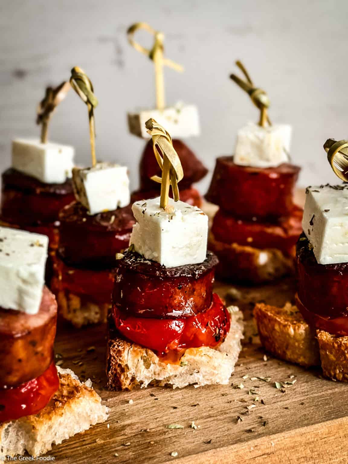 Greek Sausage Bites with Tomato & Feta - The Greek Foodie